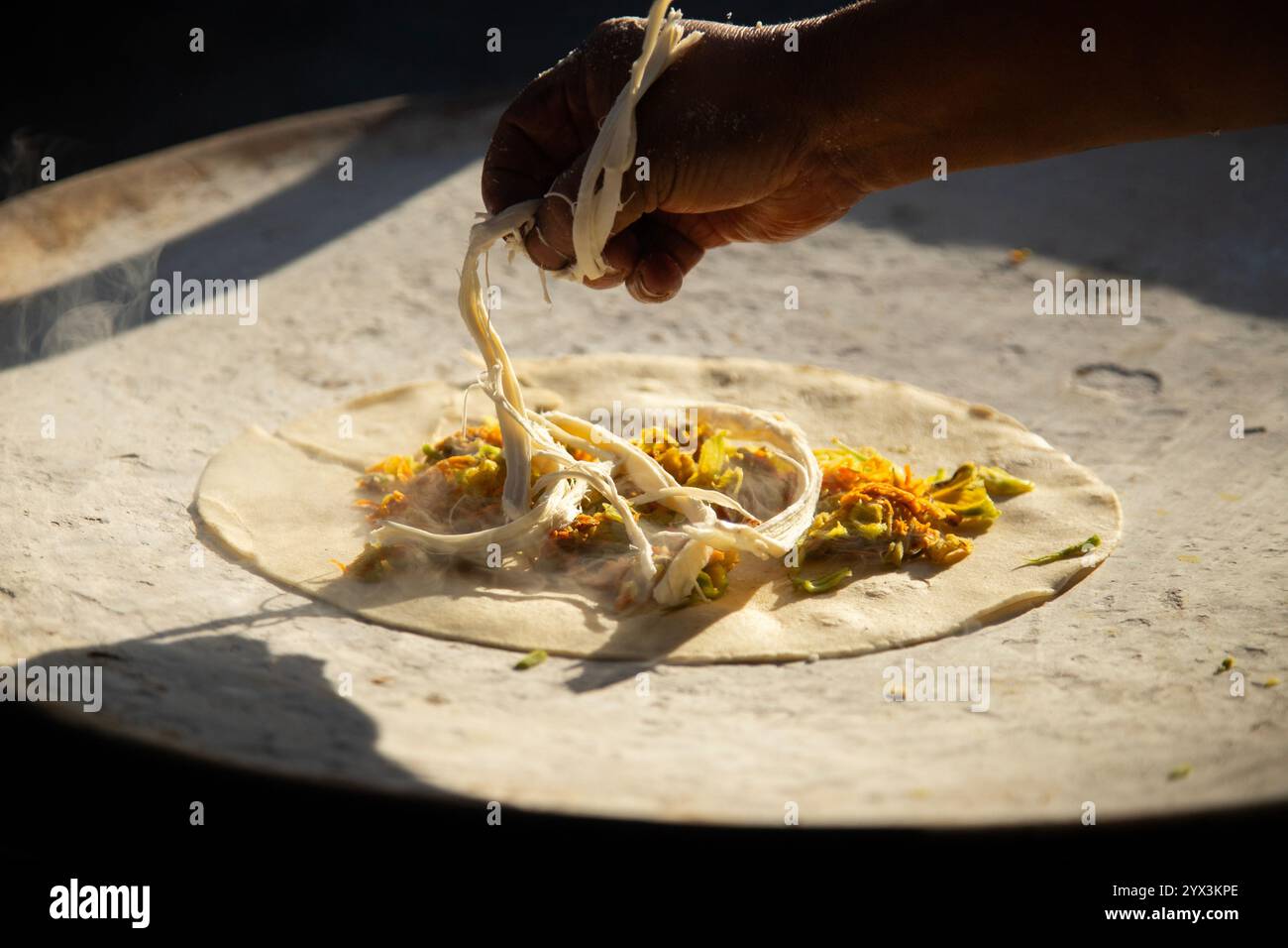 Cooking traditional squash blossom quesadillas on a comal in the Oaxaca ...