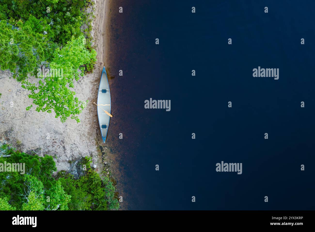 Aerial View of Canoe on Sandy Shoreline with Blue Water and Gree Stock ...