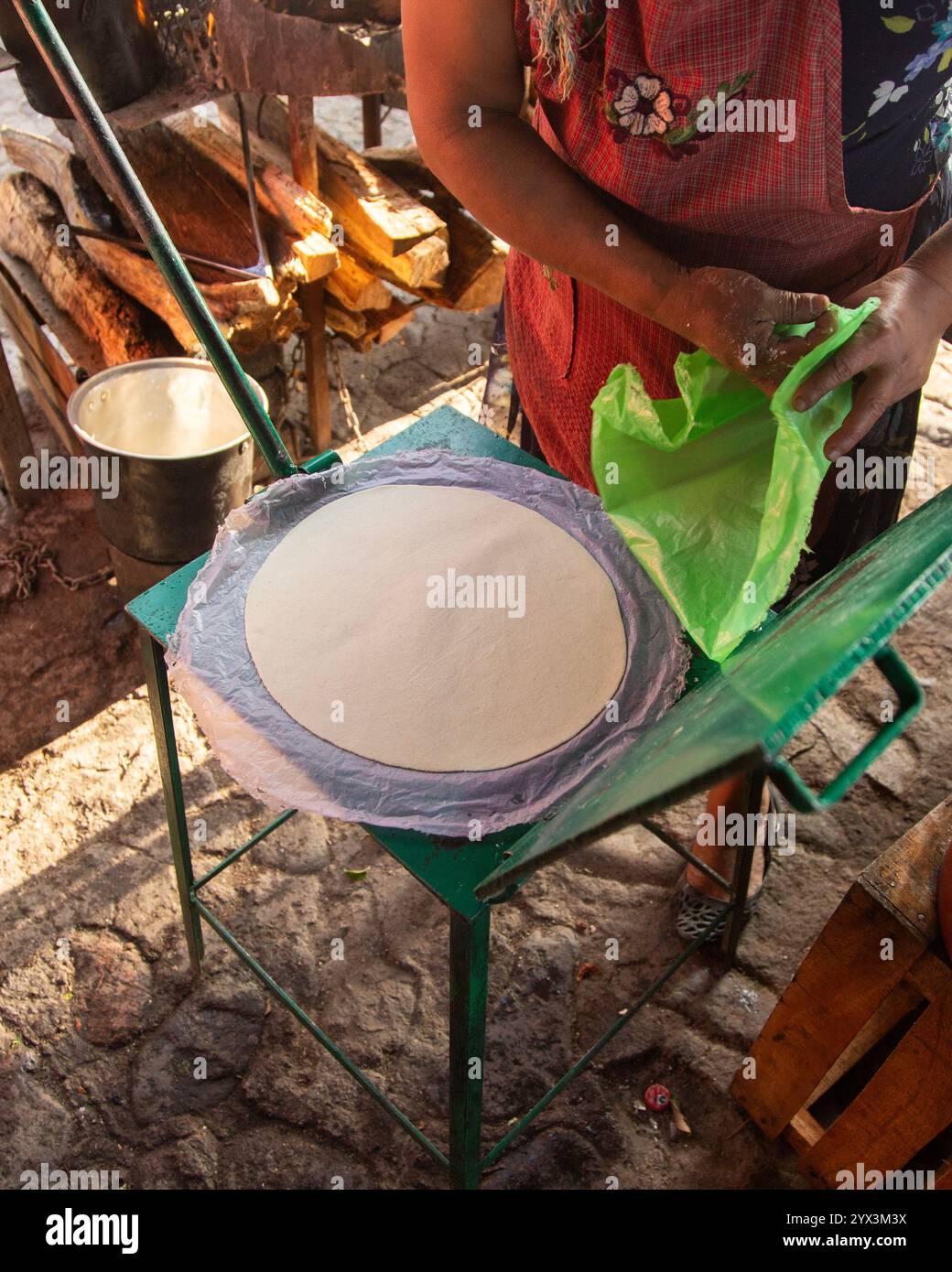 Preparing corn tortillas by hand for traditional quesadillas in the ...