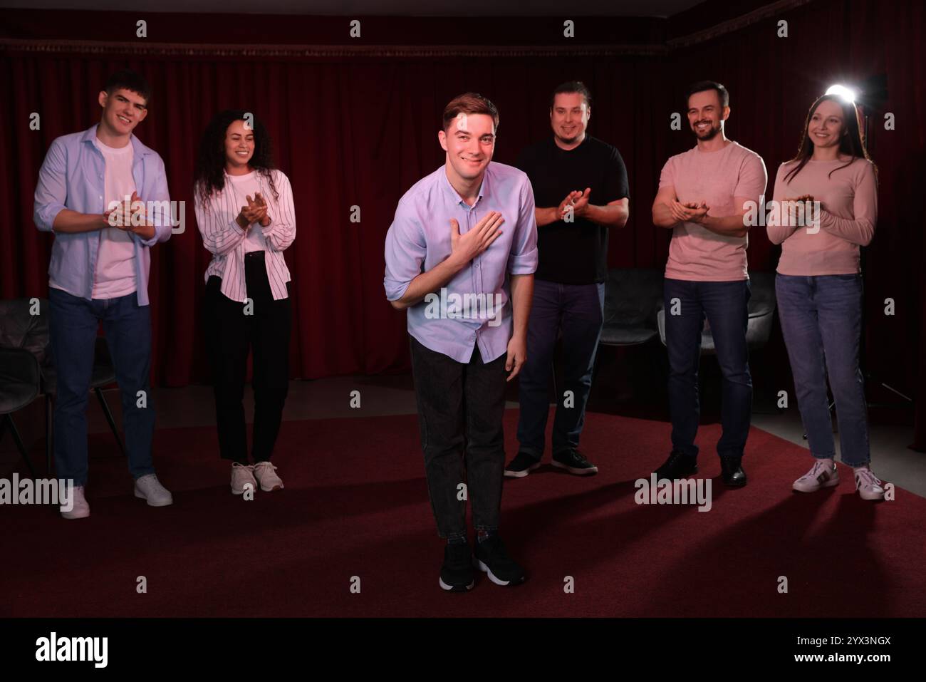 Professional actors bowing on stage in theatre Stock Photo - Alamy