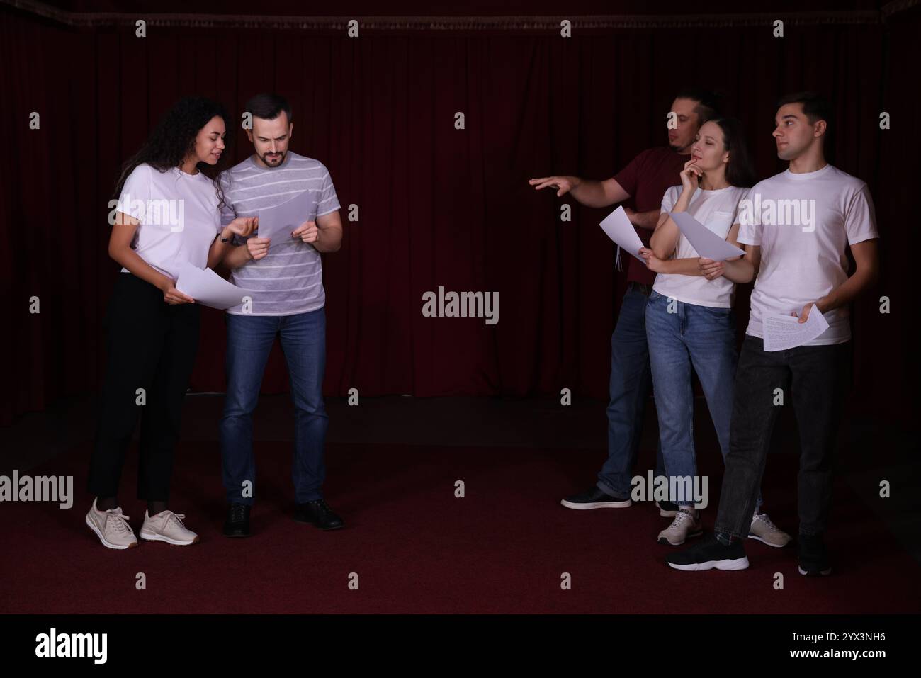 Professional actors with their scripts rehearsing in theatre Stock ...