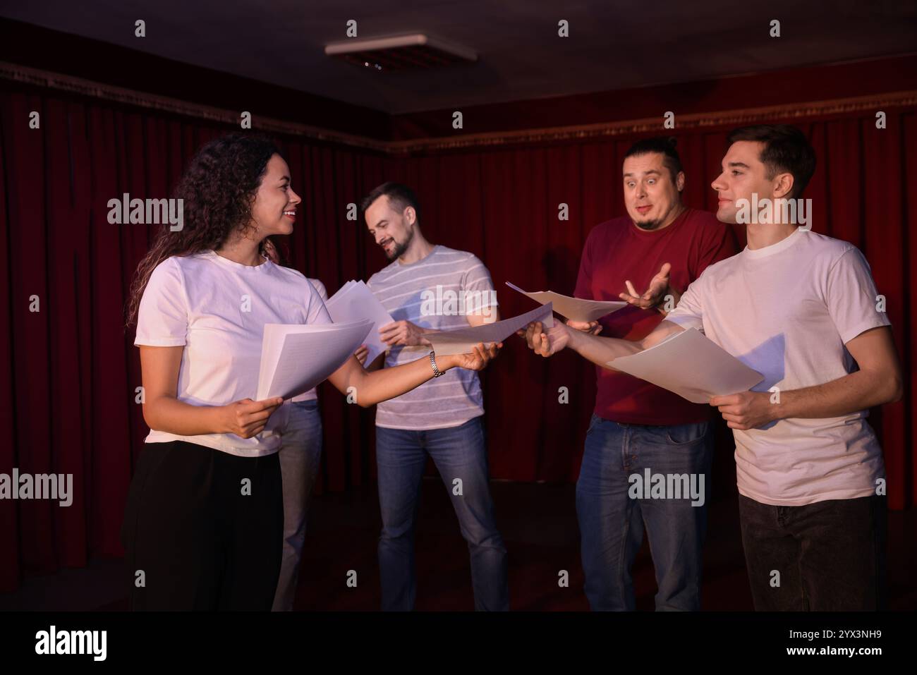 Professional actors with their scripts rehearsing in theatre Stock ...