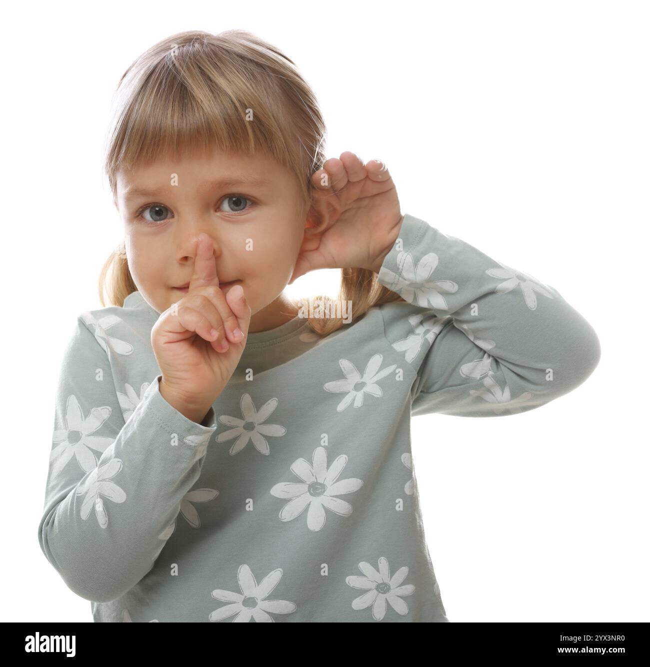 Little girl showing hand to ear gesture on white background Stock Photo ...