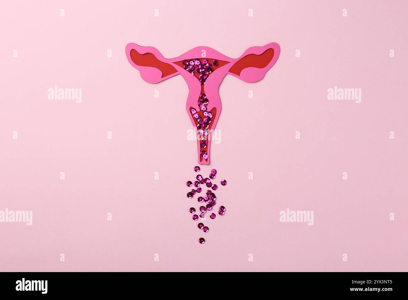 Menstruation. Paper uterus with sequins on pink background, top view ...