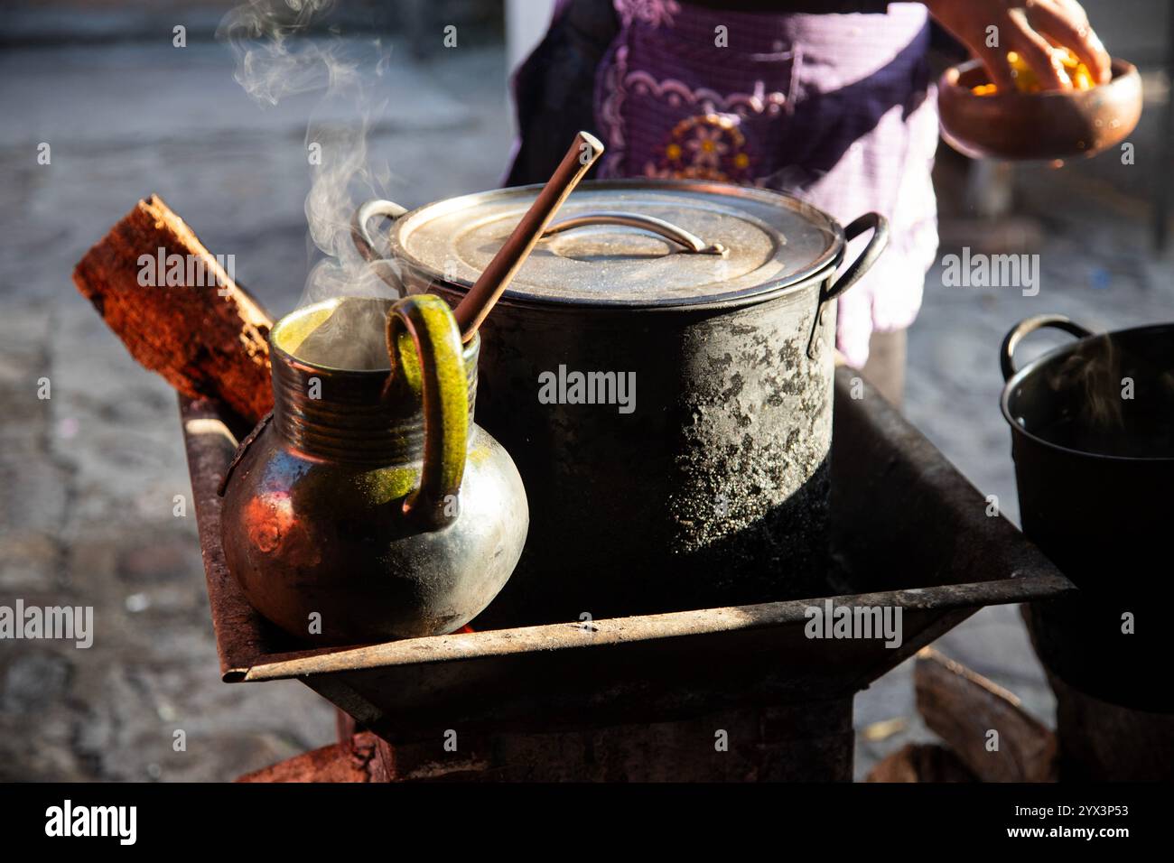 Clay and iron pots at a street food stand in Oaxaca cooking traditional ...