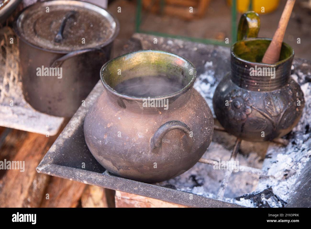 Clay and iron pots at a street food stand in Oaxaca cooking traditional ...