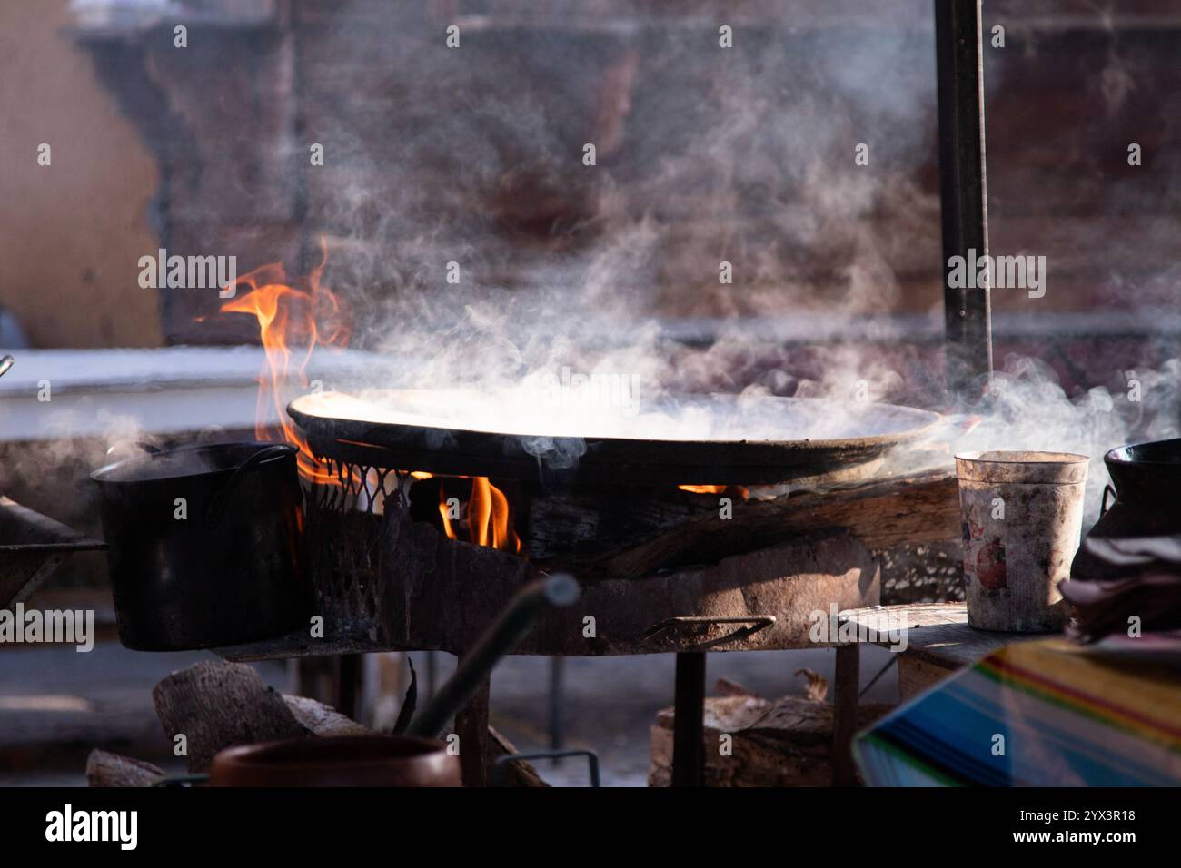 Traditional Mexican comal working with fire and wood at a street food ...