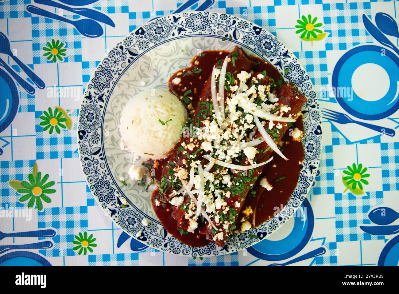 Traditional enchiladas with Oaxaca cheese, red mole and rice ...