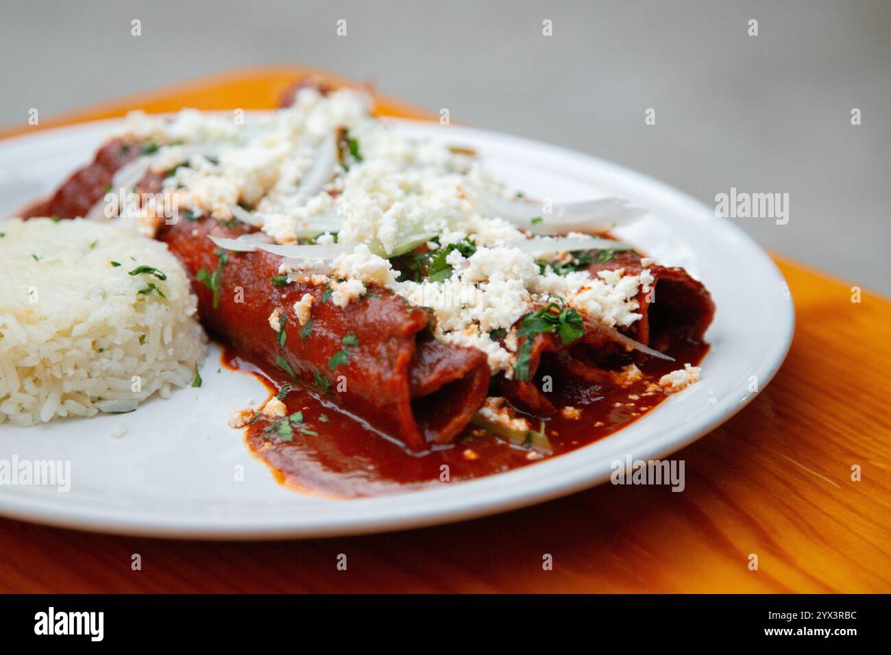 Traditional enchiladas with Oaxaca cheese, red mole and rice ...