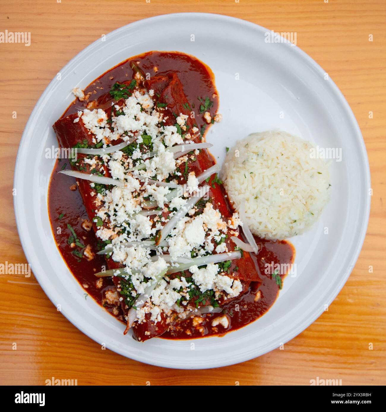 Traditional enchiladas with Oaxaca cheese, red mole and rice ...