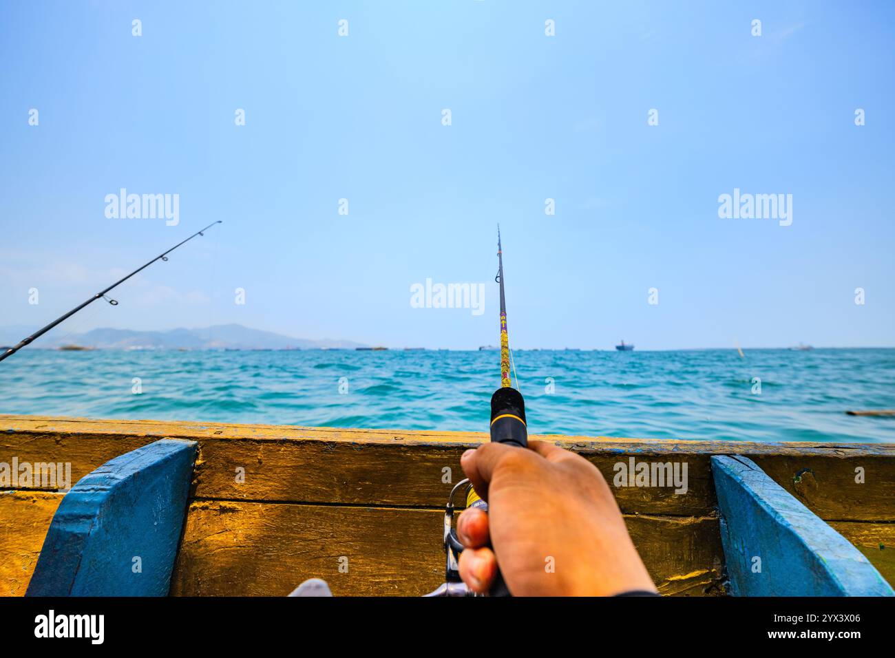 Man's Hand Gripping a Fishing Rod During a Coastal Expedition. Man ...