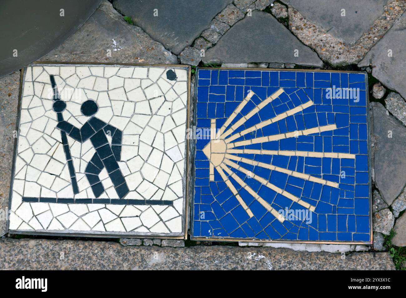 Close-up of a mosaic stone plaque set into pavement in front of ...