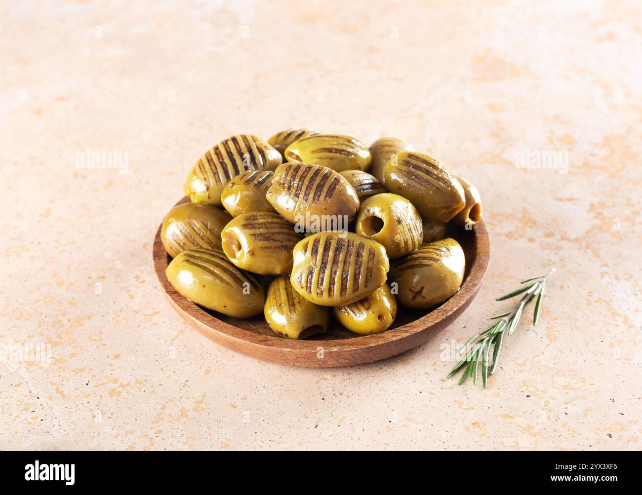 Grilled olives in a wooden bowl. Appetizers. Mediterranean, vegan food ...