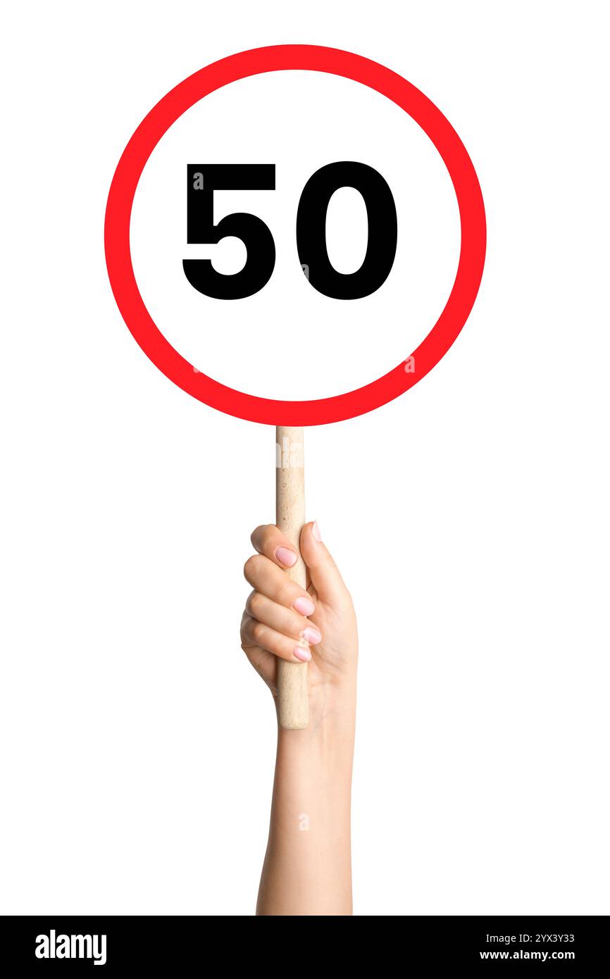 Speed limit sign 50 in a person’s hand on a blank background. Great for ...