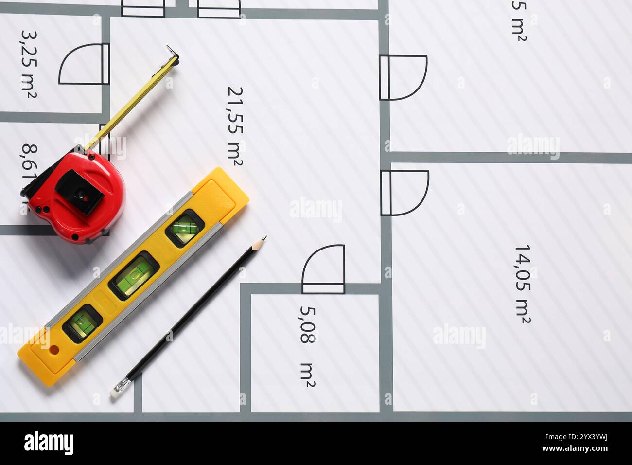 Pencil, measuring tape and building level on different architectural ...