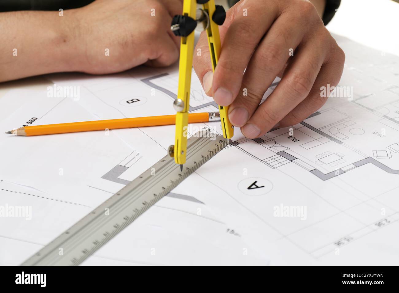 Architect working with project, closeup. Different technical drawings on table Stock Photo - Alamy