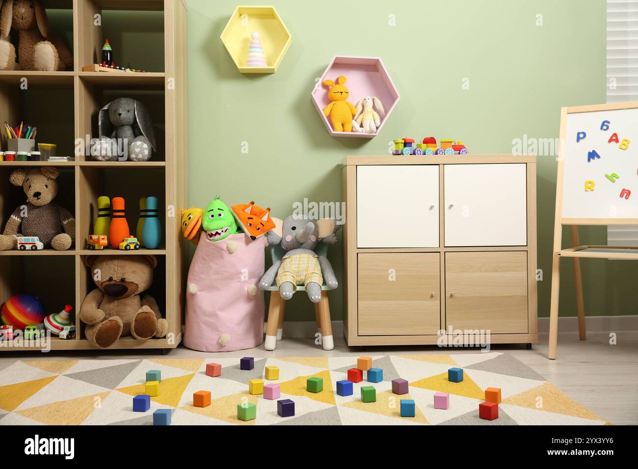 Colorful cubes on carpet and different toys in child's room Stock Photo ...