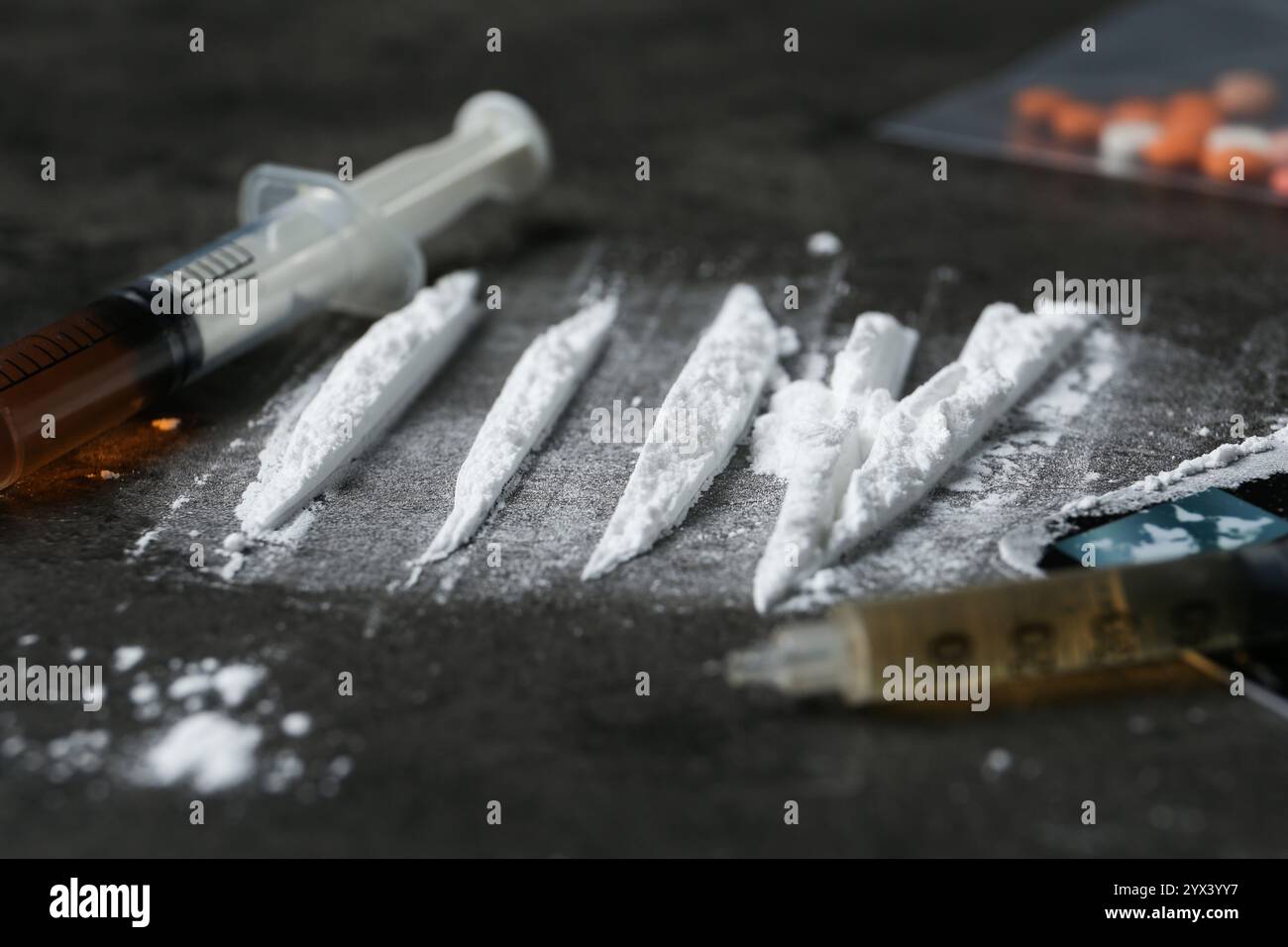 Drug addiction. Powder, syringes and credit card on gray textured table ...