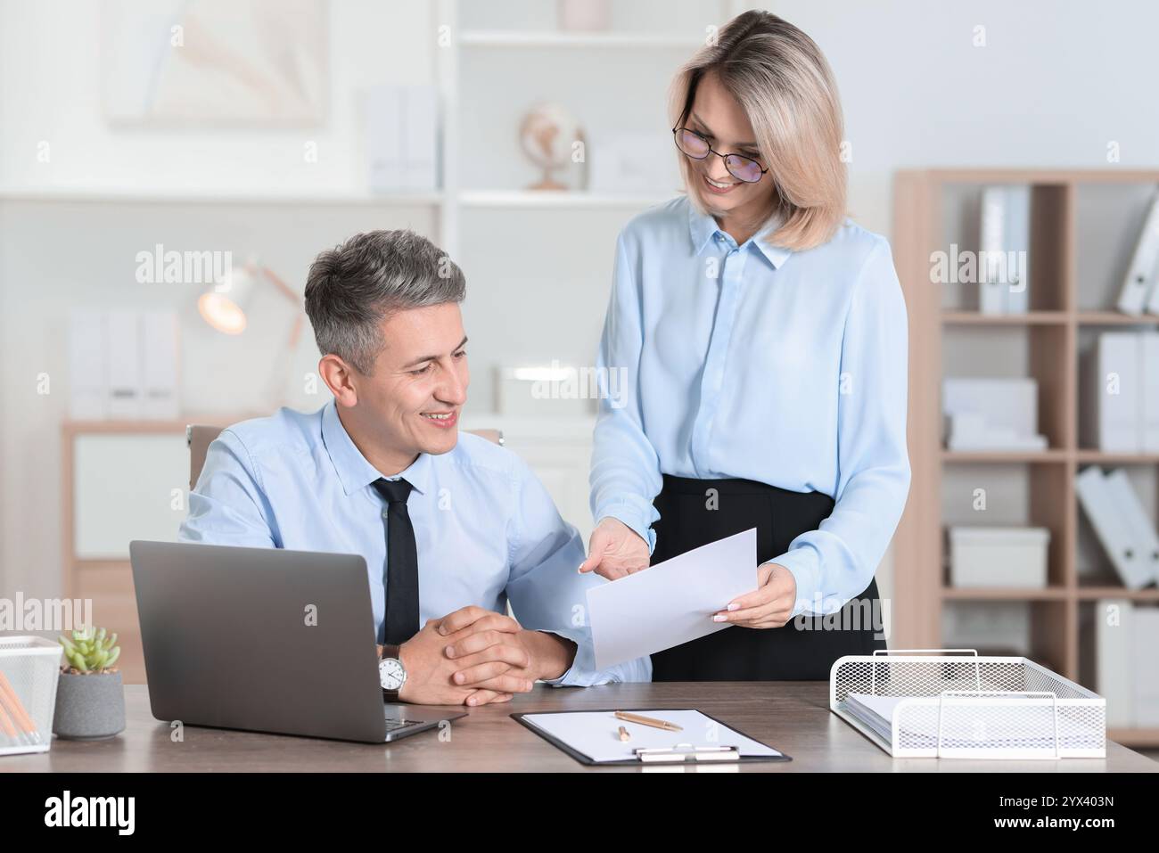 Middle aged employees working together in office Stock Photo - Alamy
