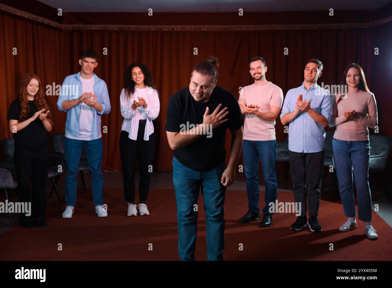 Professional actors bowing on stage in theatre Stock Photo - Alamy