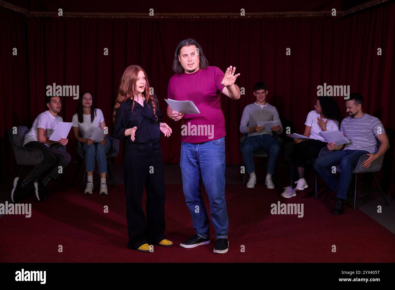 Professional actors with their scripts rehearsing in theatre Stock ...