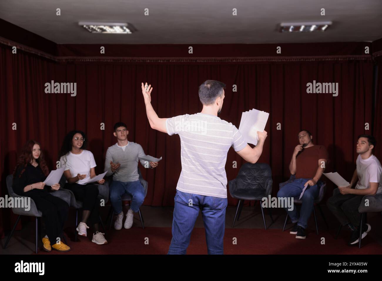 Professional actors with their scripts rehearsing in theatre Stock ...