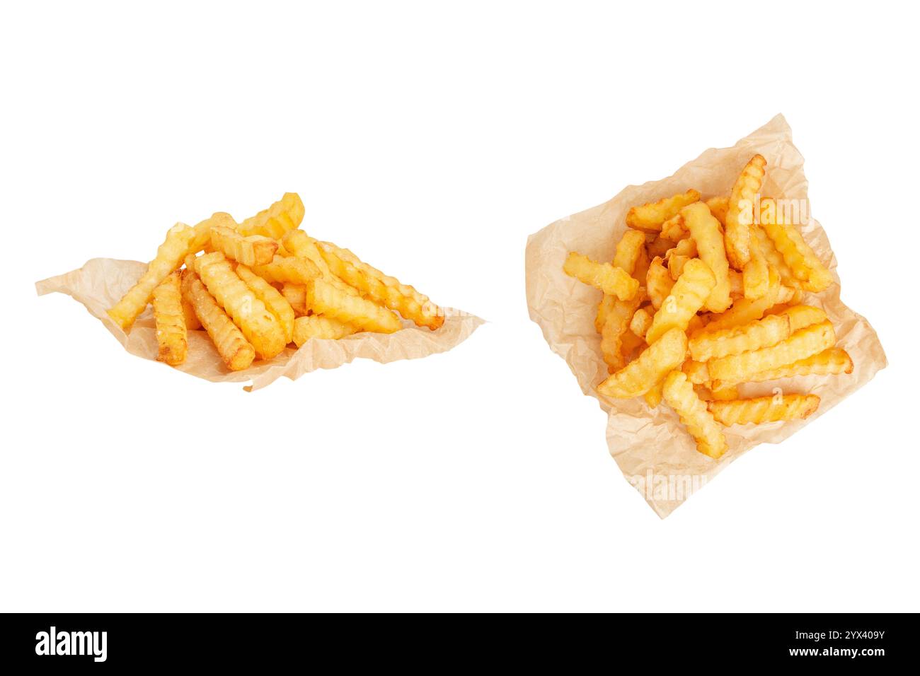 French fries ribbed on paper on empty background Stock Photo - Alamy