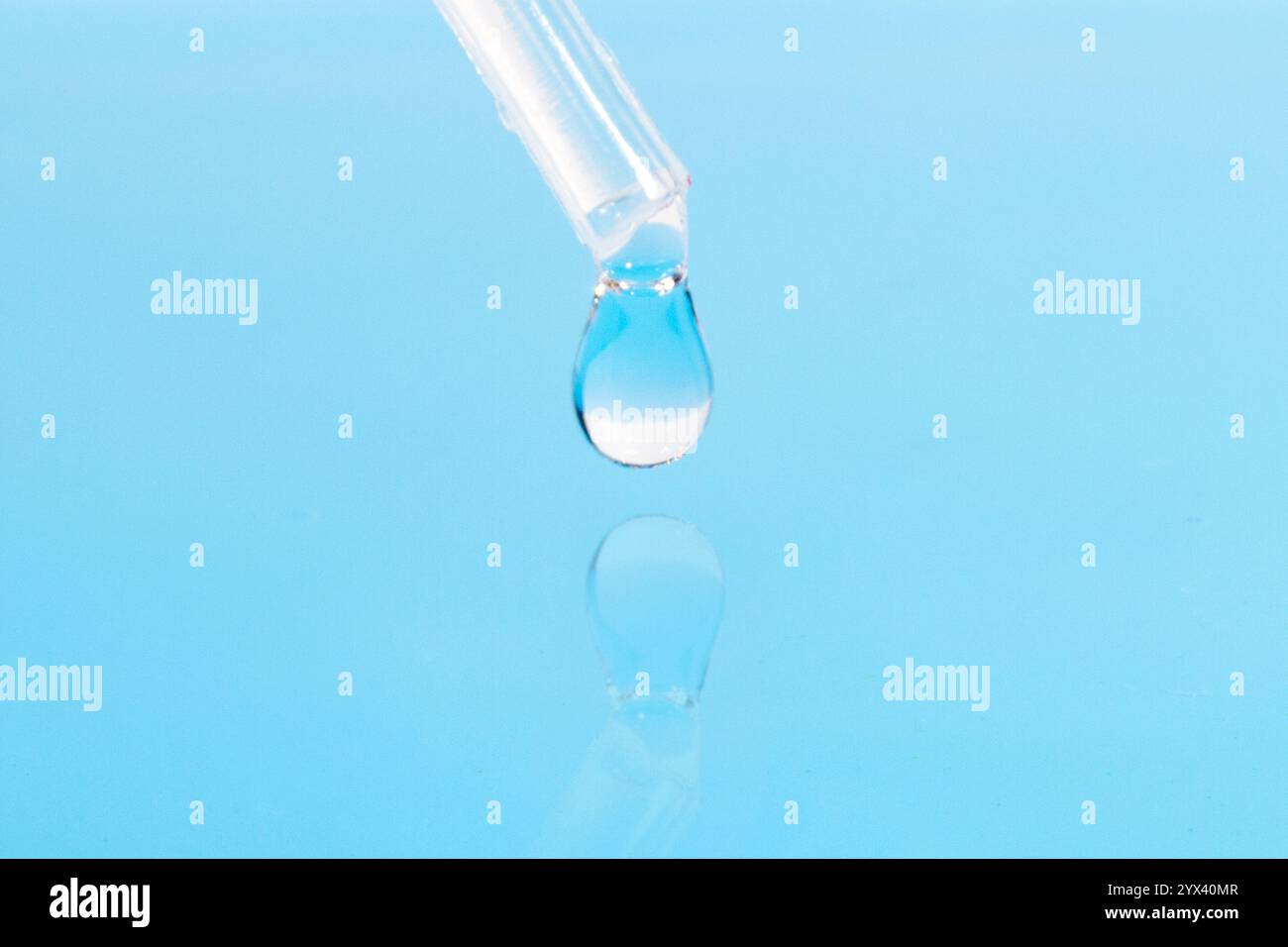 dripping water drop over water surface with reflection Stock Photo - Alamy