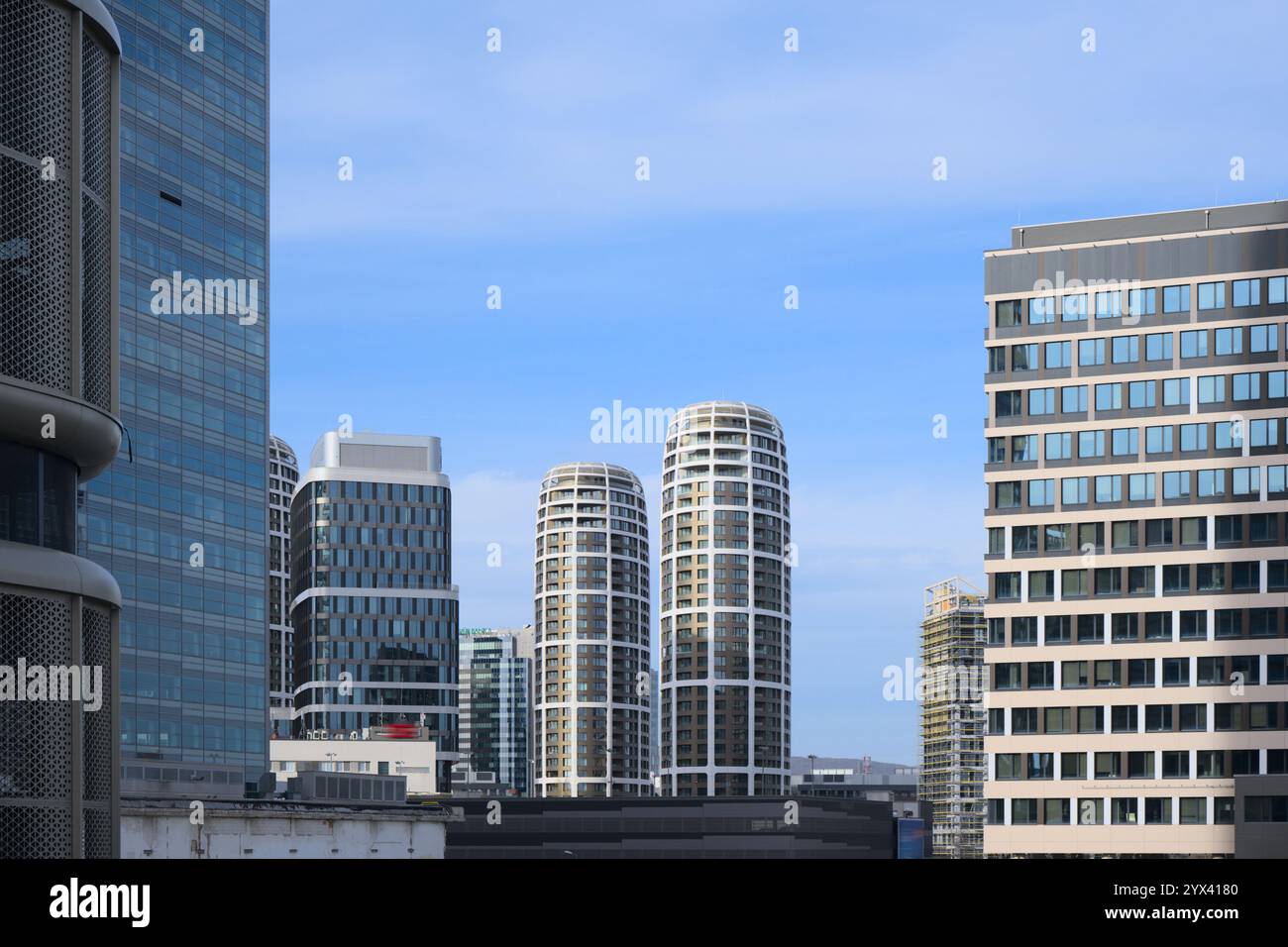 Modern high-rise buildings with unique rounded architecture under a ...