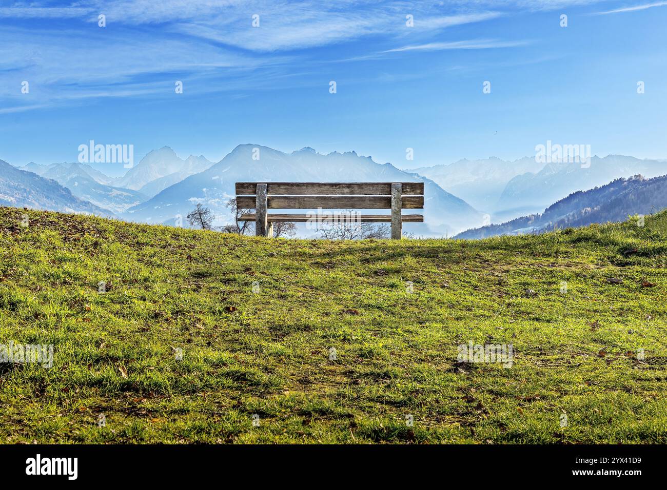 A bench inviting hikers to rest and enjoying the stunning view over the ...