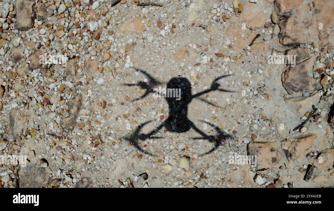 Shadow of drone landing on a dusty rock Stock Photo - Alamy