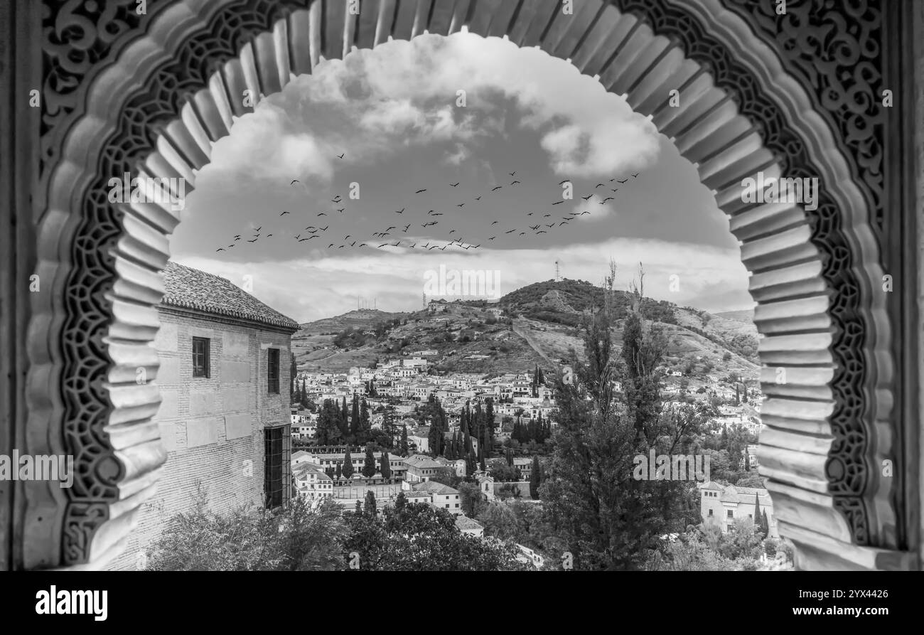 View of the Albayzin district from an arched window in the Alhambra ...