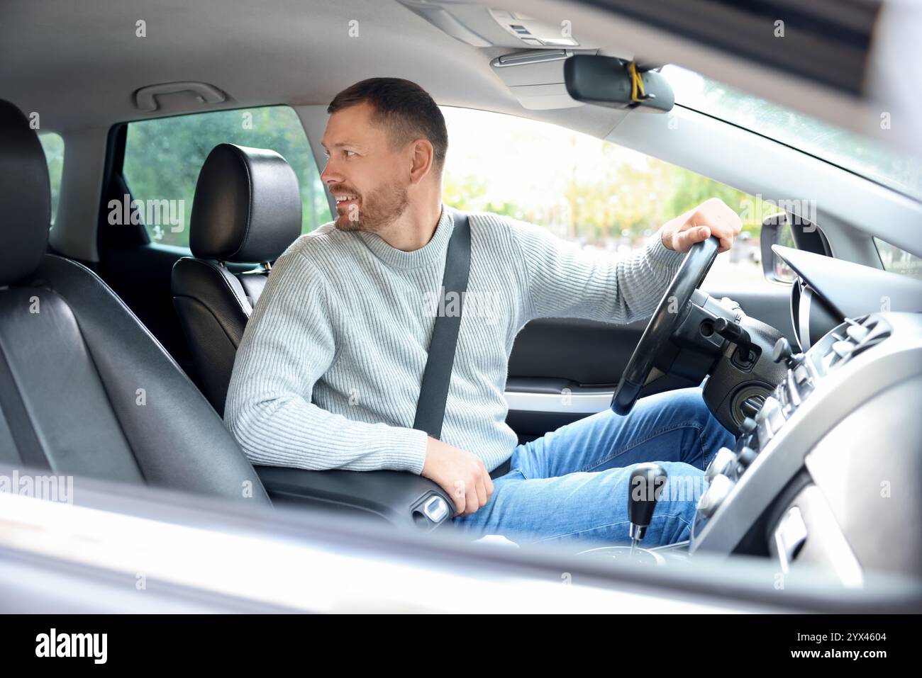 Man driving modern car, view through window Stock Photo - Alamy