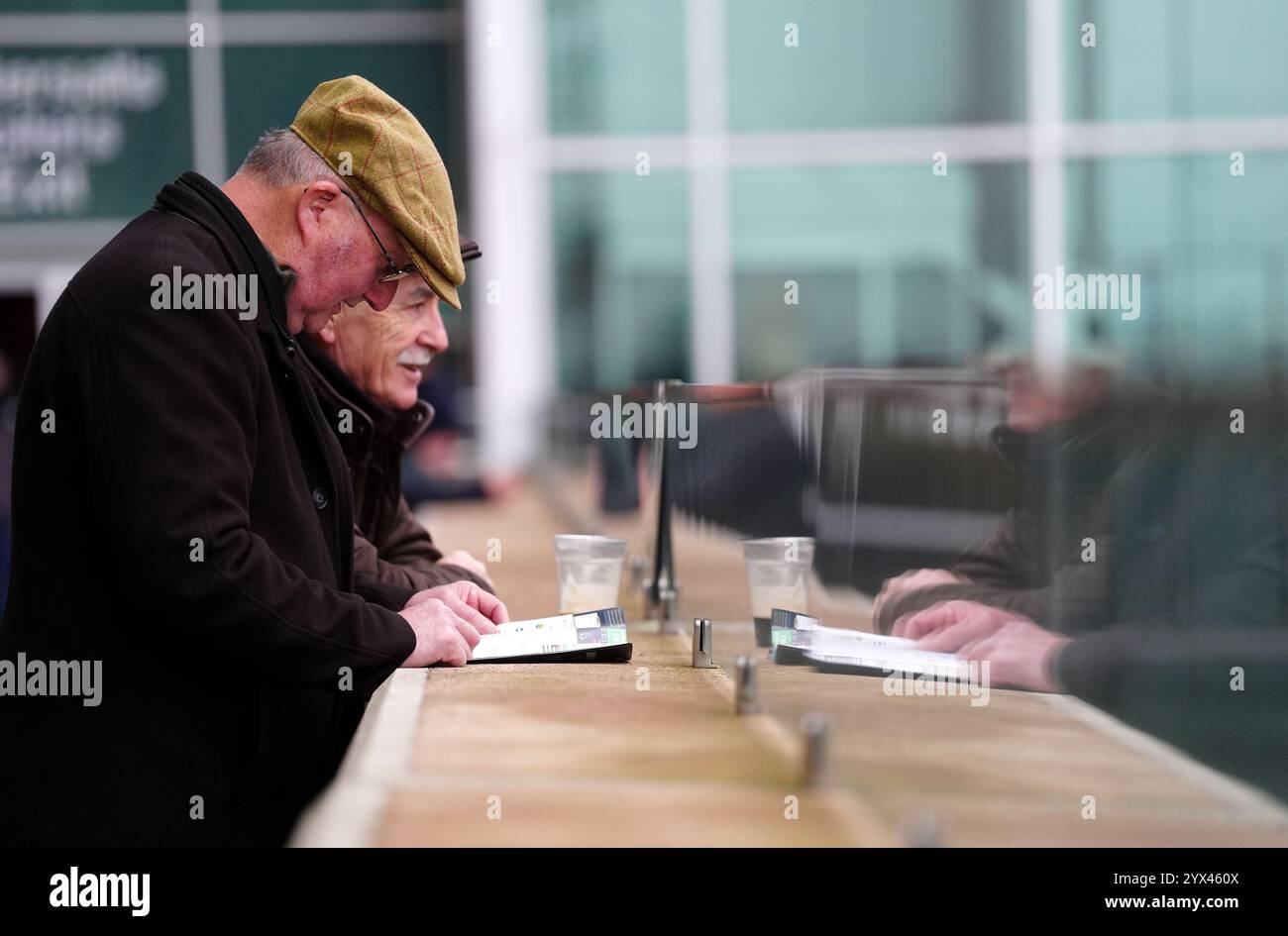 Racegoers check the form guide during The Christmas Meeting at ...