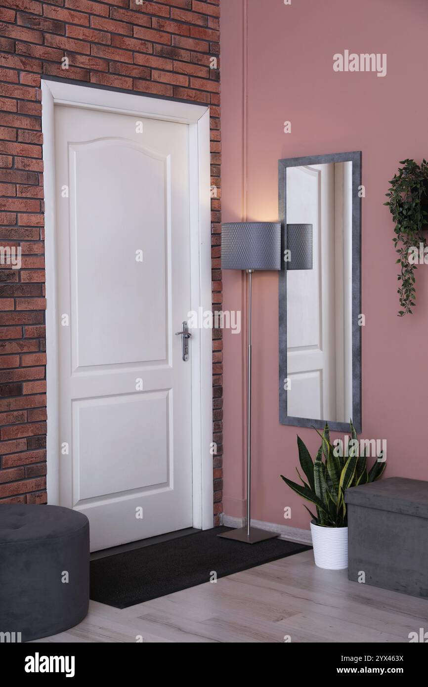 Stylish hallway interior with mirror and pouf Stock Photo - Alamy