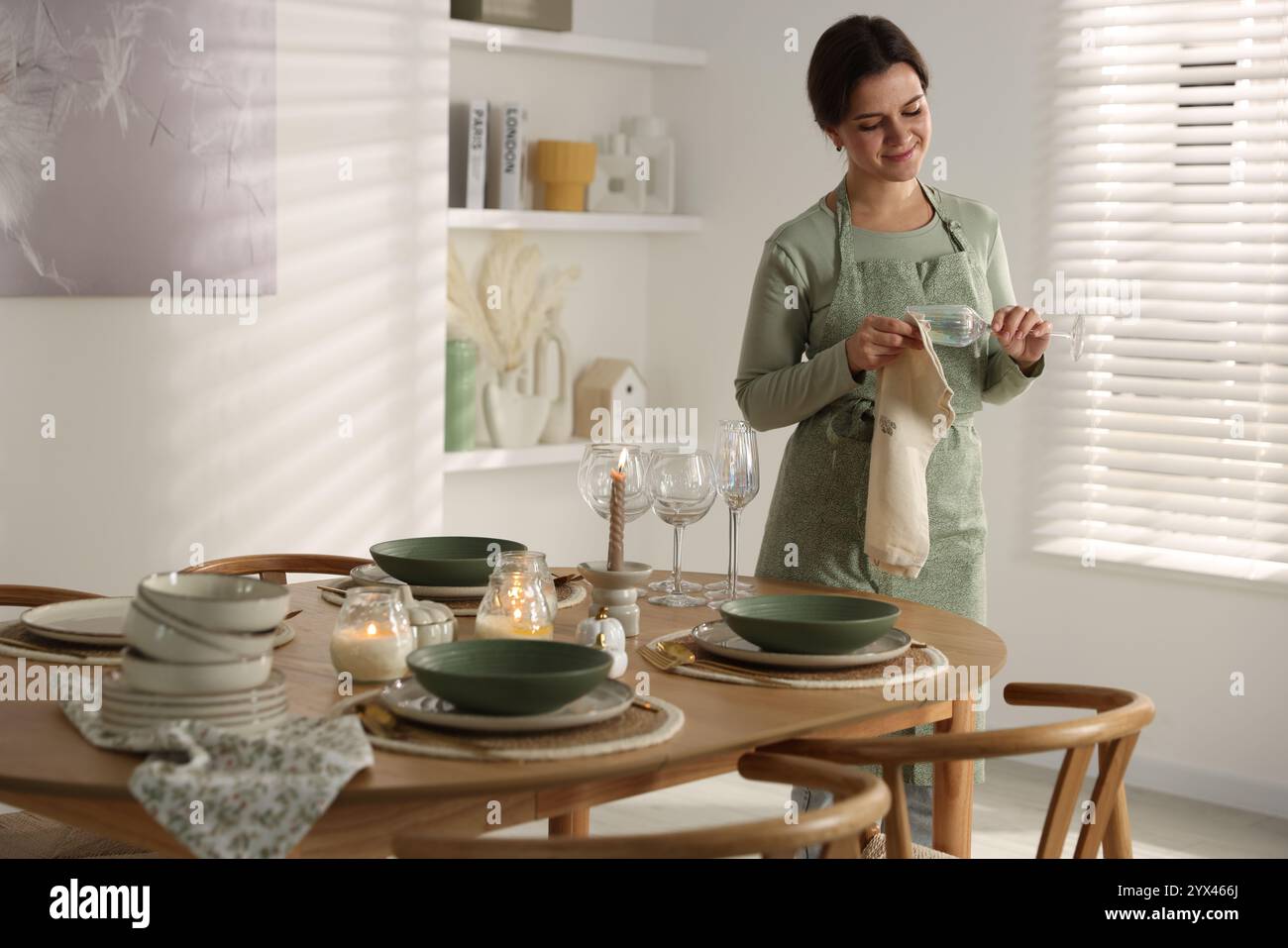 Woman setting table for dinner at home Stock Photo - Alamy