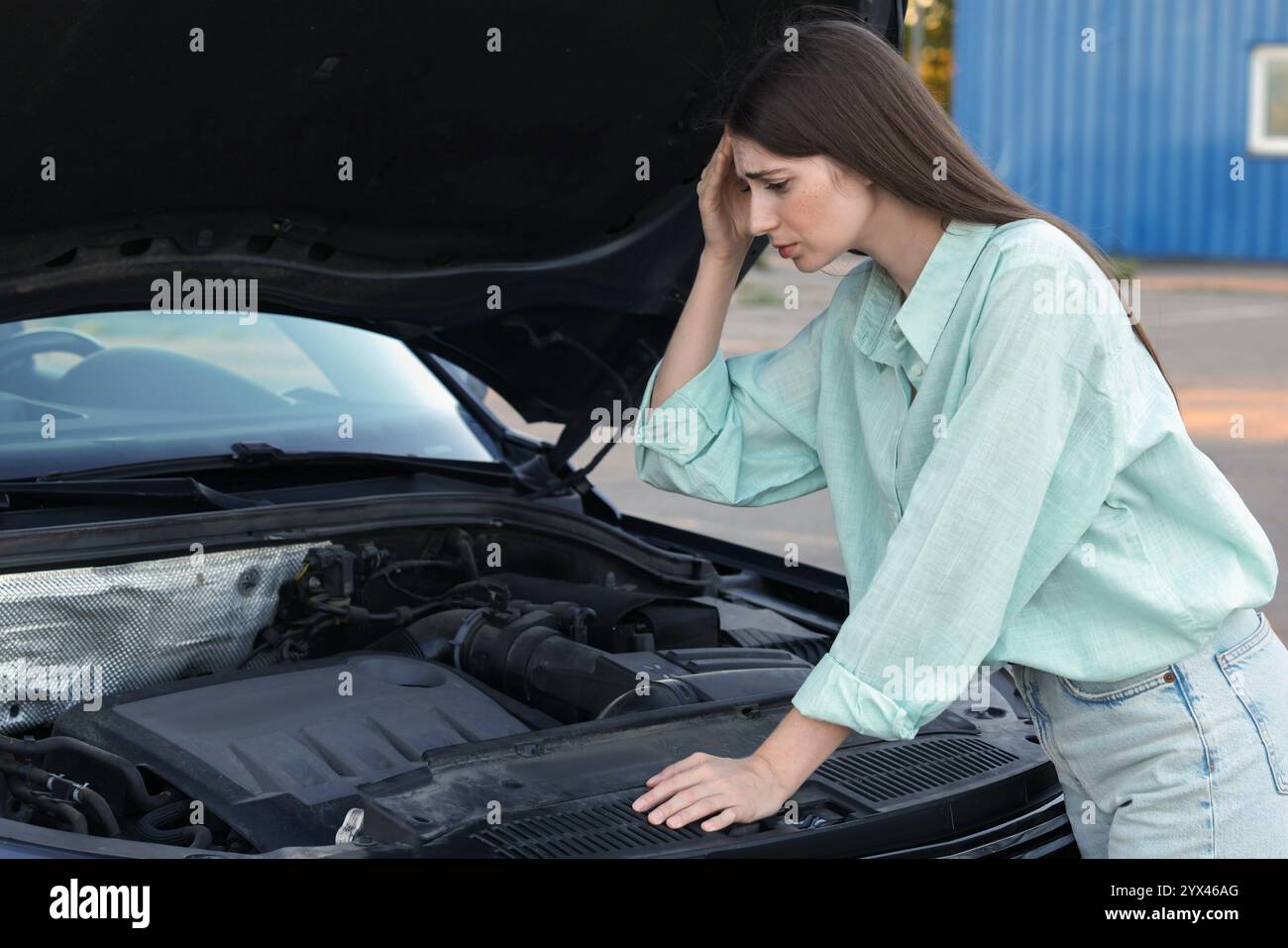 Woman looking under hood car hi-res stock photography and images - Alamy