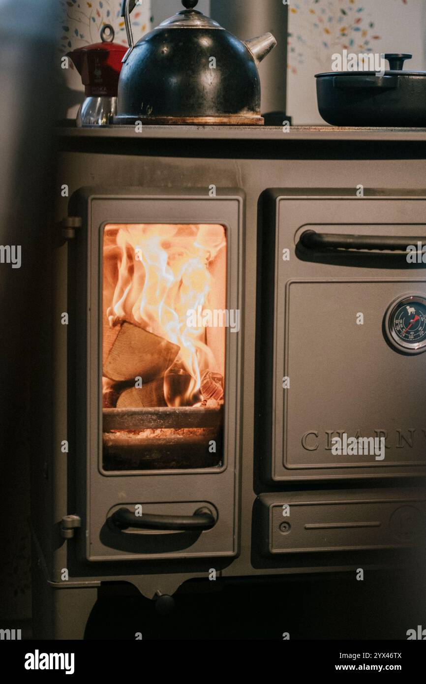 Lit fire on wood stove hi-res stock photography and images - Alamy