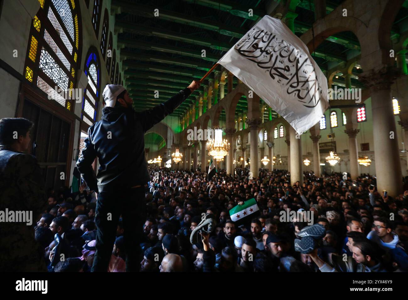 Syrians gather inside the 7th century Umayyad Mosque after the Friday ...
