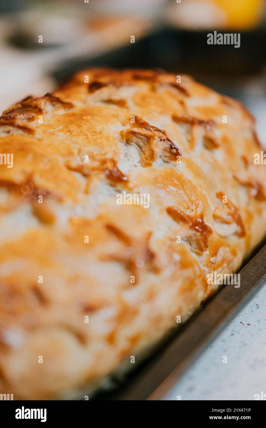 A loaf of bread with a star pattern on it. The bread is golden brown ...