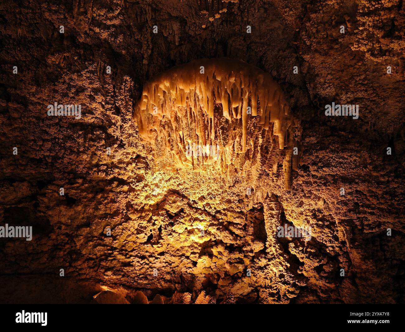 a giant Stalactites stone in the cave with yellow light Stock Photo - Alamy