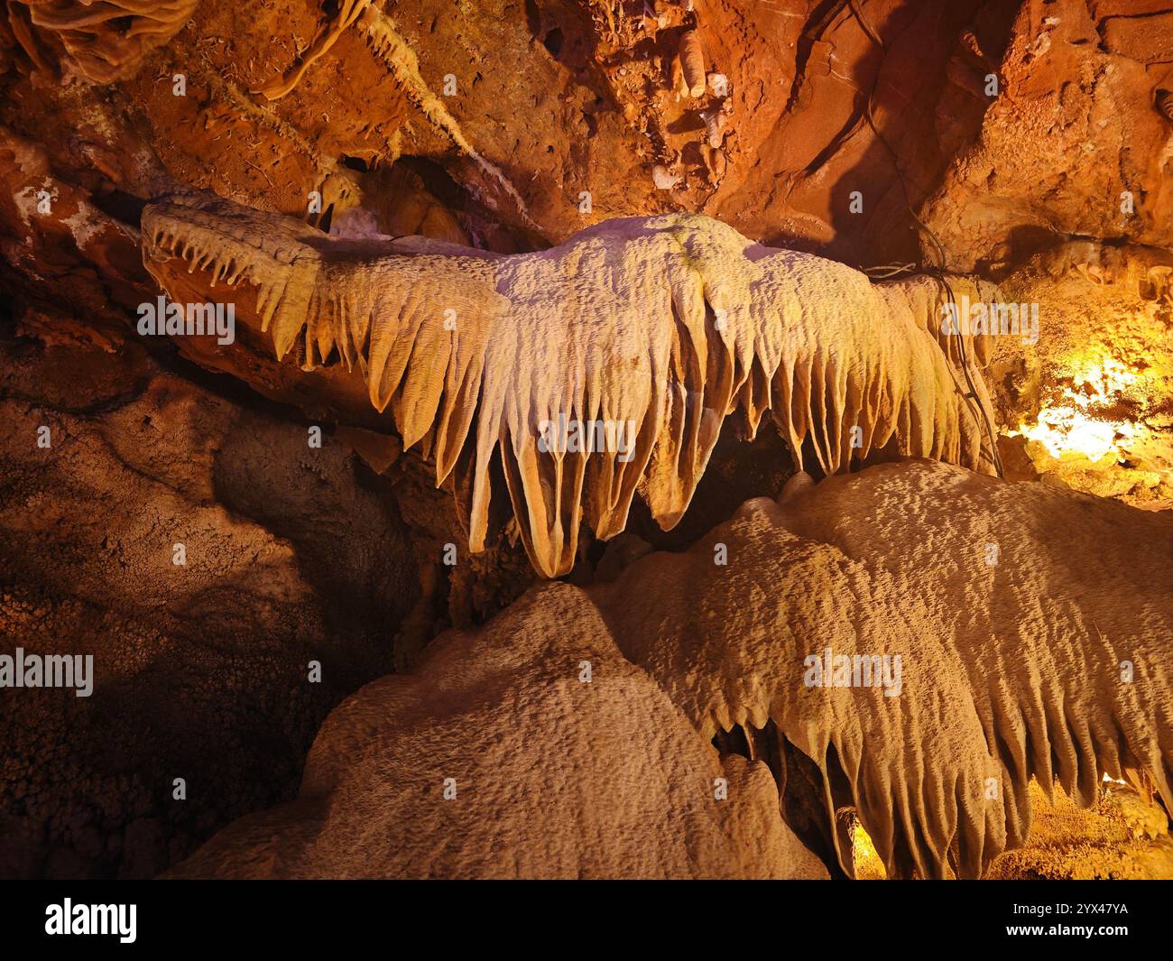cluster of Stalactites looks like waterfall in the cave with yellow ...