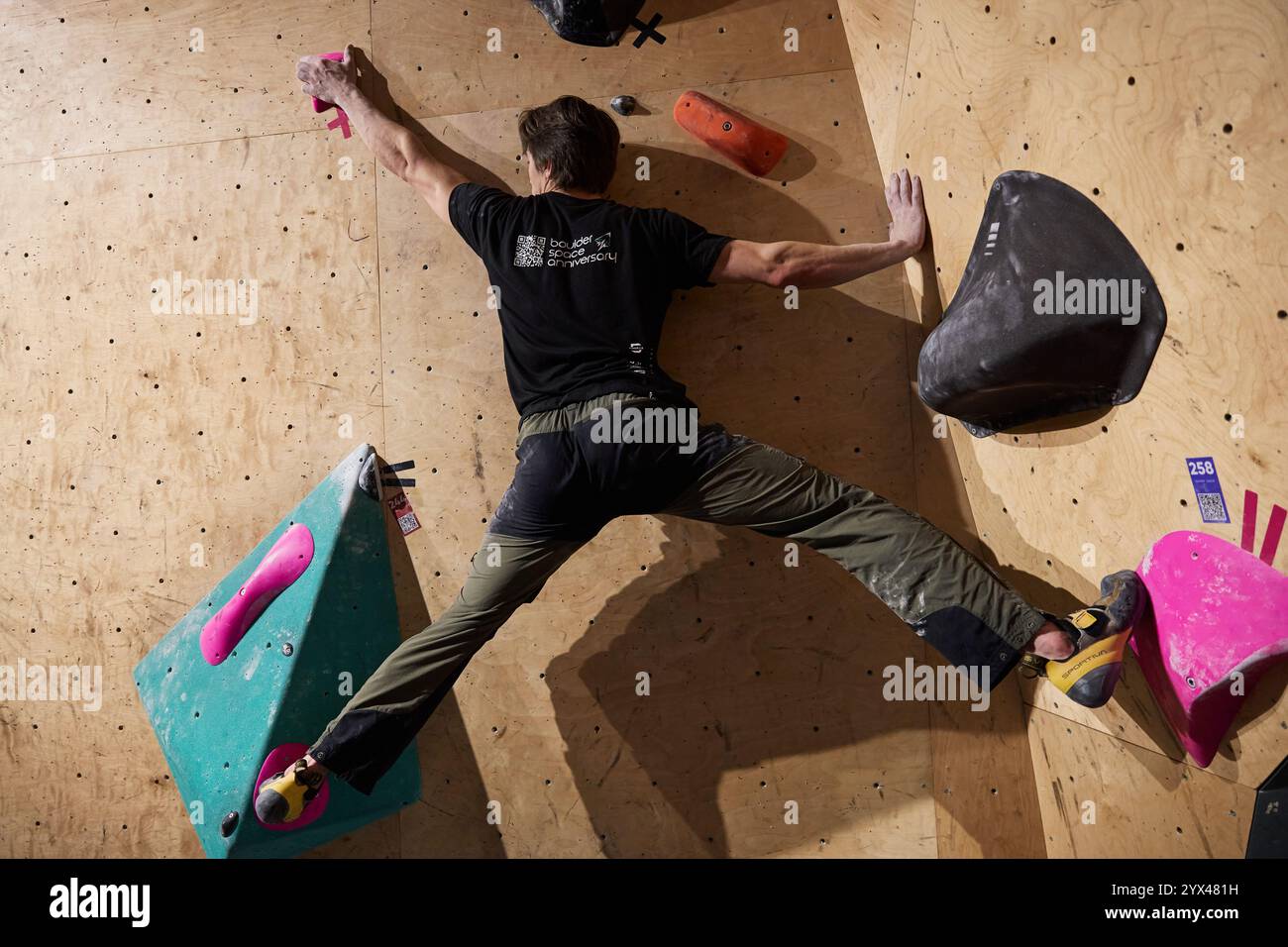 Professional climber hanging on a wall in bouldering gym. Kyiv - 23 ...