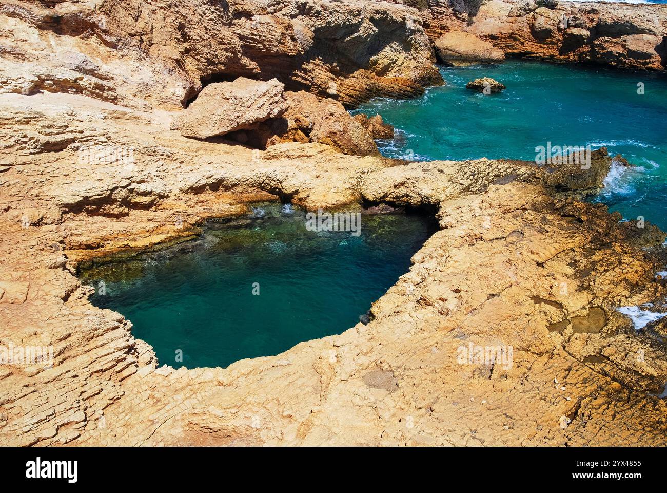 Rock pool in rocky coastline of Koufonissi, Cyclades Greek Islands ...