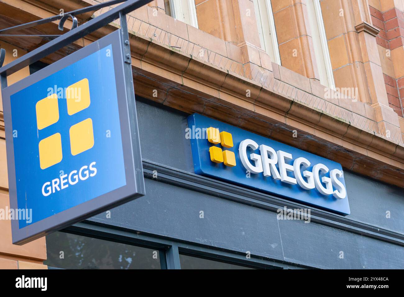 Close up view of exterior signs/signage above a Greggs bakery shop on a ...