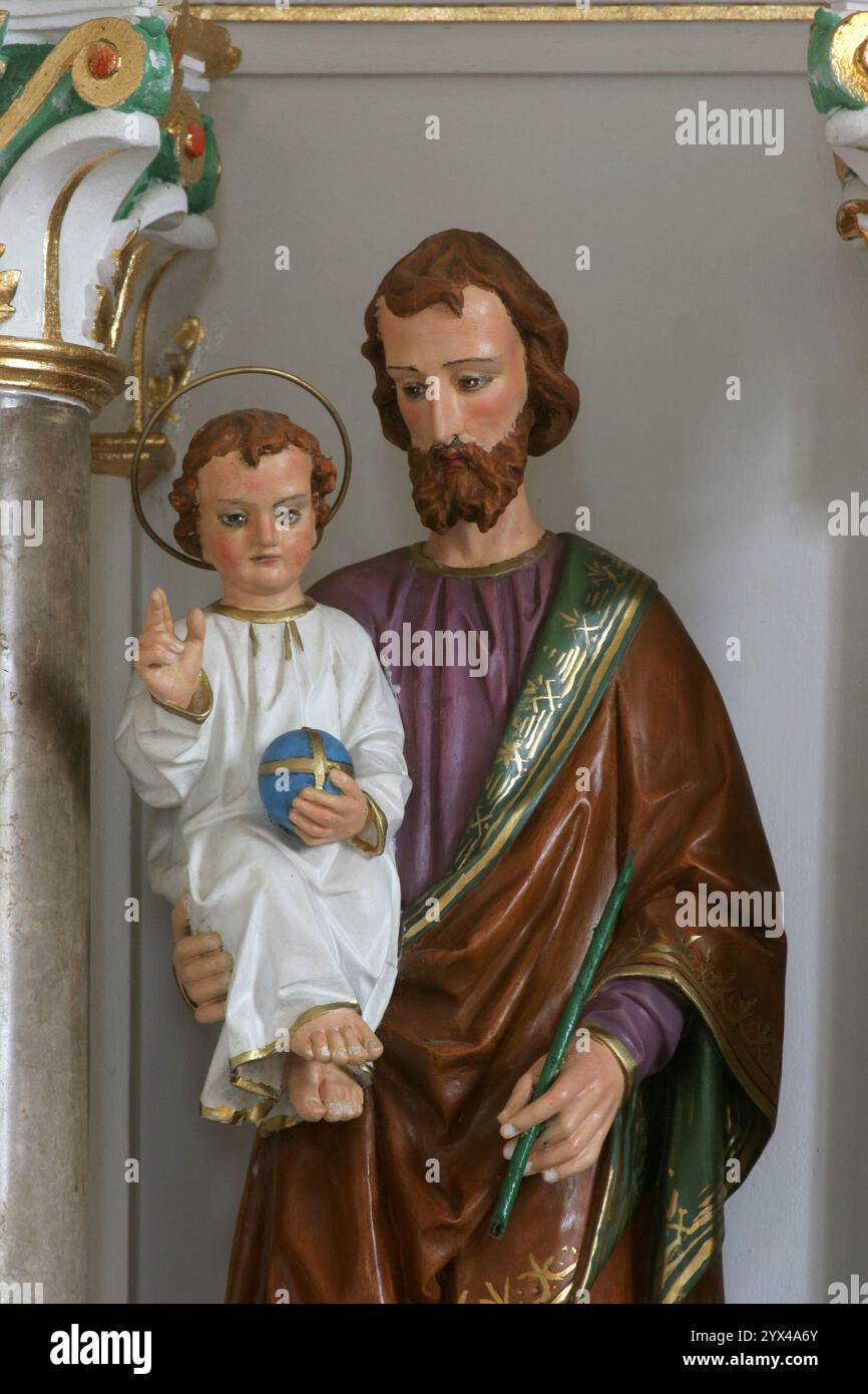 Saint Joseph with child Jesus, statue on the main altar in parish church Name of Mary in Svilaj ...