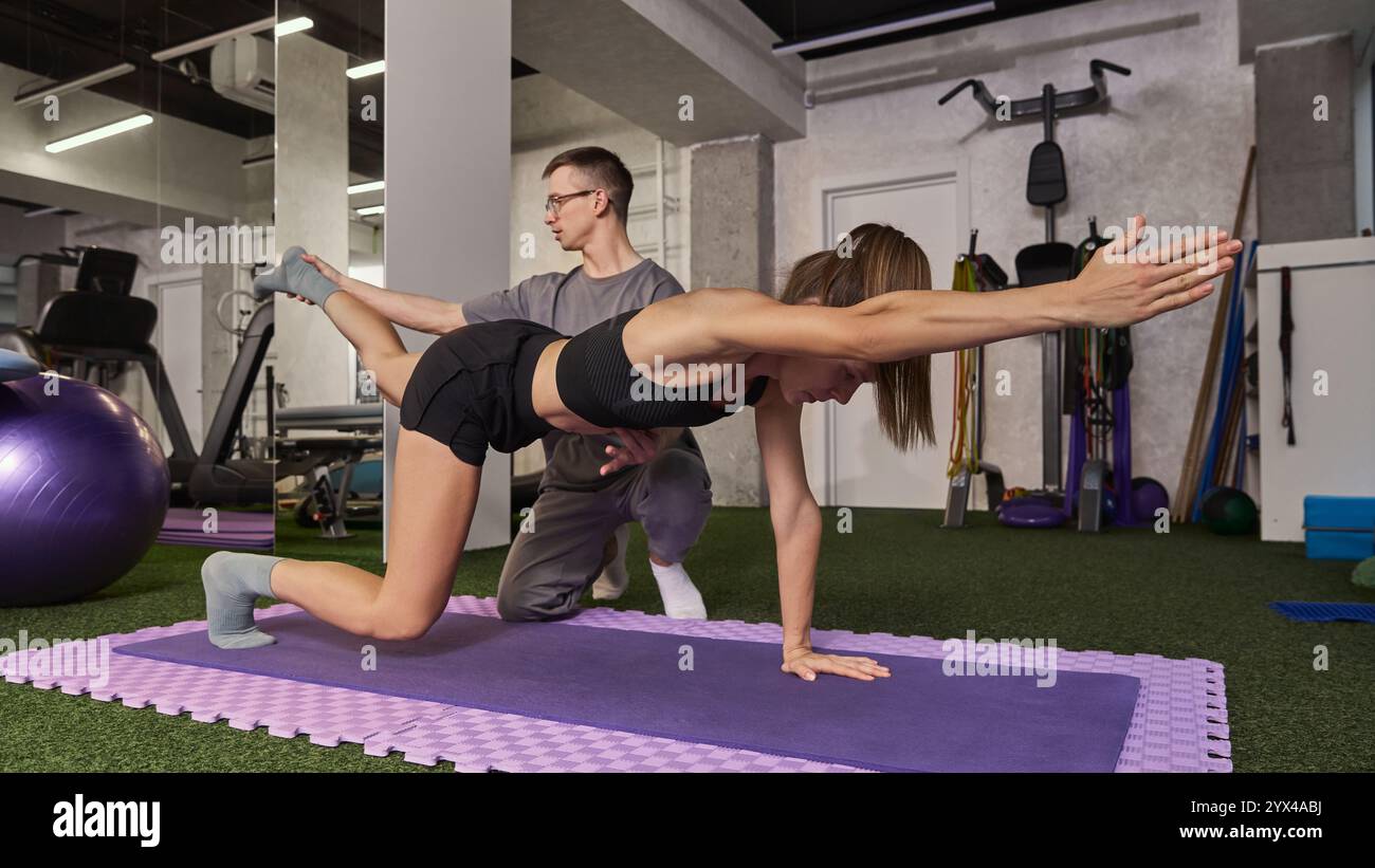 Physiotherapist guiding patient through bird dog exercise for balance ...