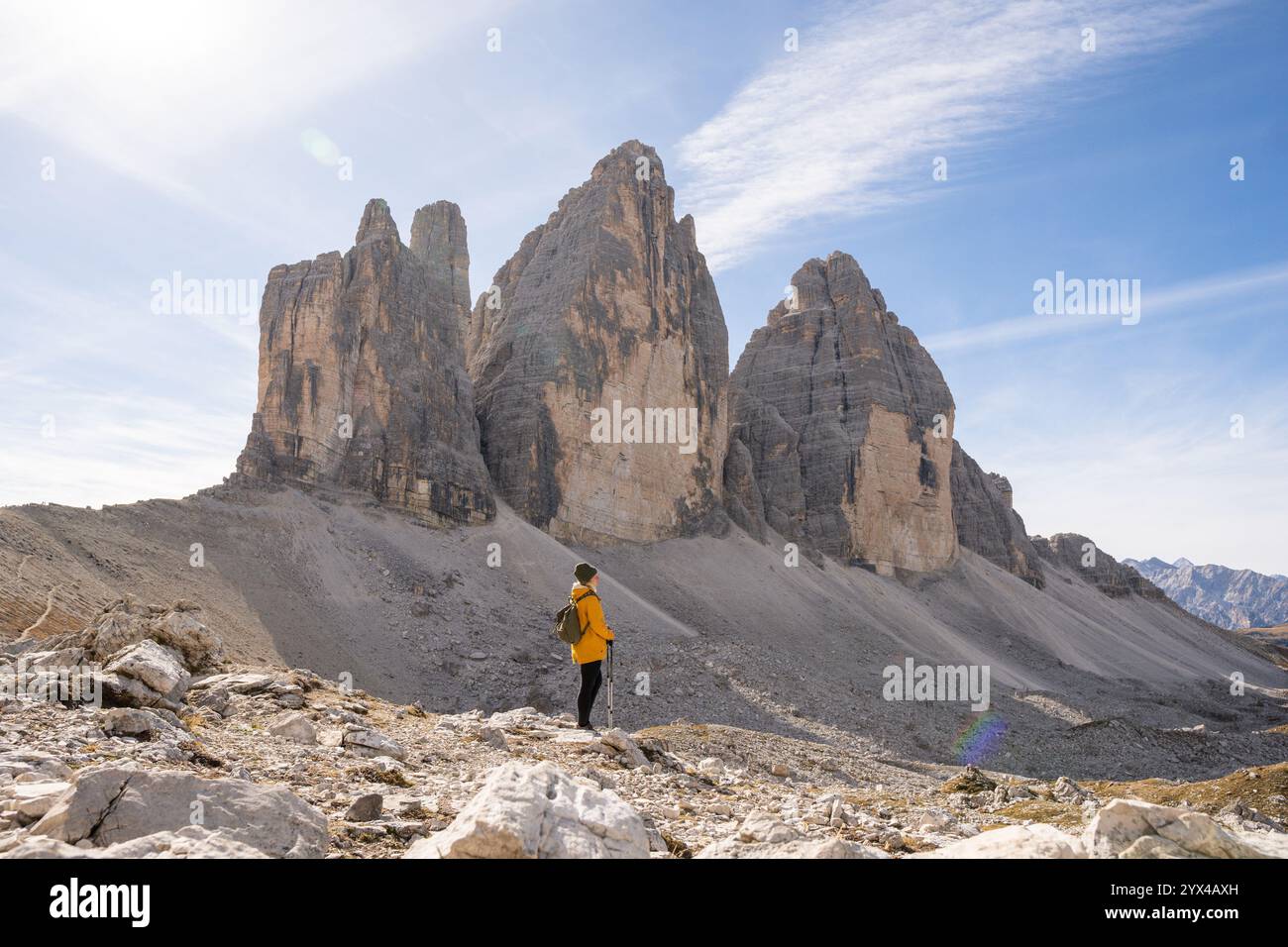 Woman in yellow raincoat hiking near Tre Cime di Lavaredo mountain in ...
