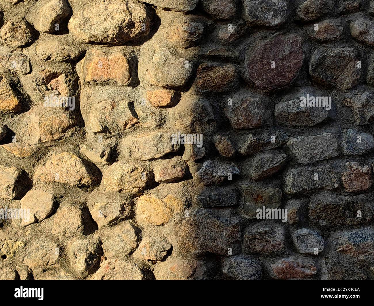 Duality of Light and Shadow on Stone Wall Exterior Stock Photo - Alamy