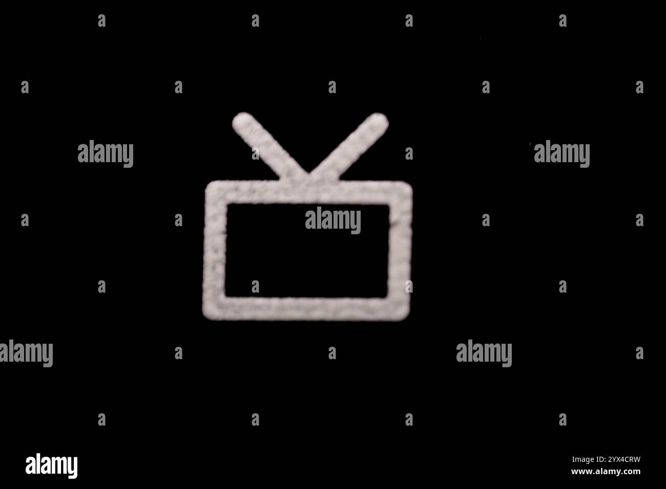 White TV remote control symbol with black reflective background in ...